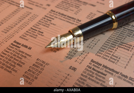 fountain pen and financial chart on table Stock Photo - Alamy