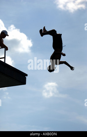 Man doing a backward jump from a springboard Stock Photo - Alamy