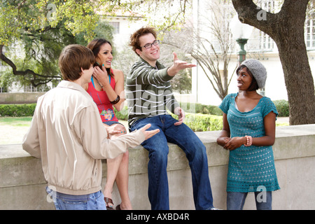Stock Photograph of four college students on campus having fun Stock ...