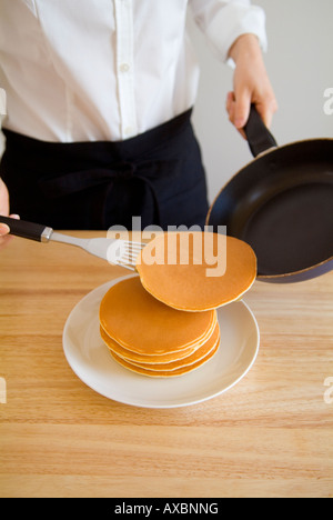 Midsection of woman cooking food Stock Photo - Alamy