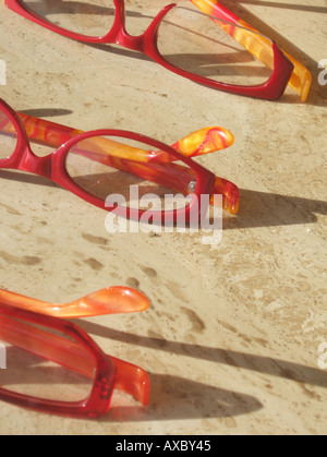 three colourful orange spectacles at opticians Stock Photo - Alamy