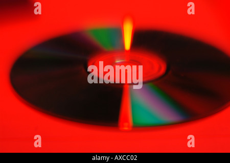 computer disc bathed in red light high color saturation Stock Photo - Alamy