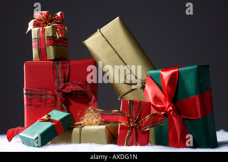 Group of parcels, one with red ribbon Stock Photo - Alamy