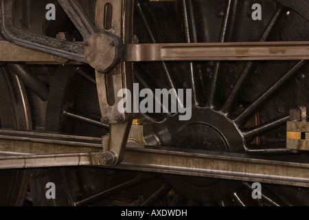 Cast iron wheel and connecting rod of a steam train Stock Photo - Alamy
