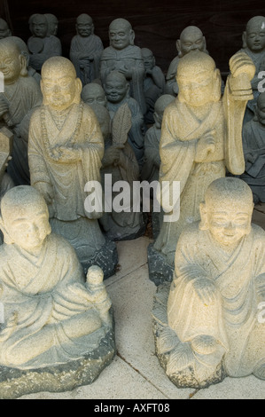 Statues stand peacefully at the Daisho in temple of Miyajima Japan ...