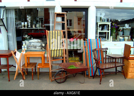 Antique shop exterior display with chairs, pile of old suitcases and ...
