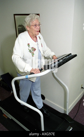 82 year old senior female checks her weight on scale and exercises to ...