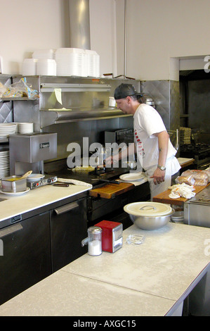 Short order cook prepares food in a small restaurant Stock Photo - Alamy