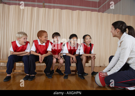 basketball coach talking to young male player in locker room Stock ...