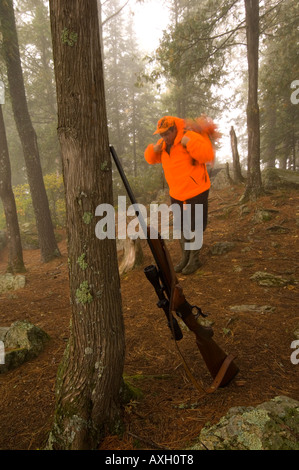 A Hunting rifle with scope leaning on a tree Stock Photo - Alamy