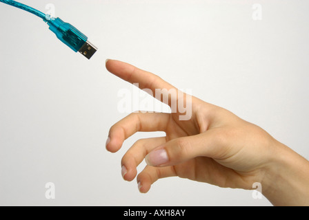 Hand reaching for USB connector, symbolizing connection and technology ...