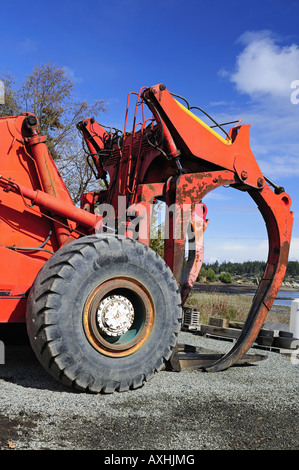 A Log Picker sorting Logs at a Log Yard near Chetwynd in Northern ...