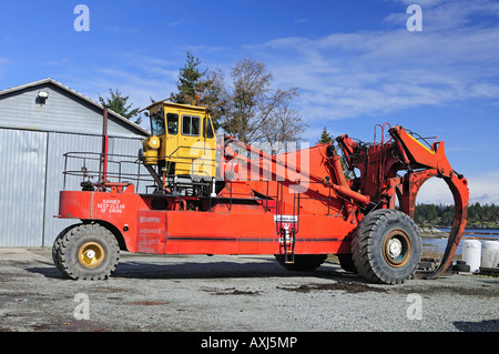 A Log Picker sorting Logs at a Log Yard near Chetwynd in Northern ...