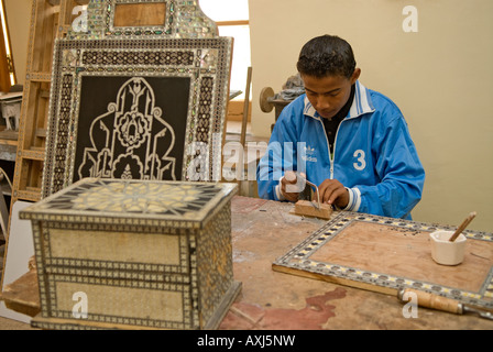 Young boy pupil engaged in shoemaking workshop at the Islamic Arts and ...