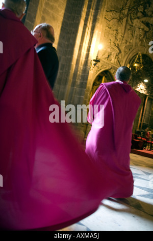 Priests with purple robes inside Seville's cathedral during Holy Week ...
