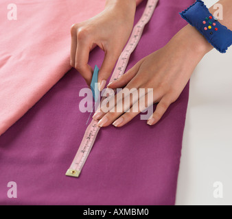 Woman cutting fabric Stock Photo - Alamy