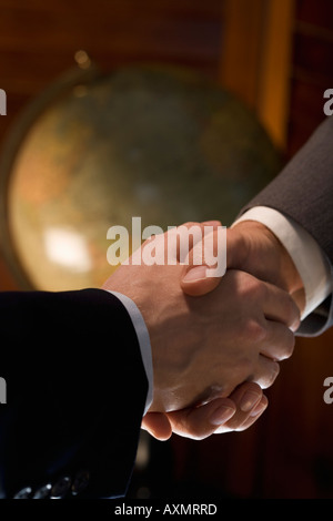 Two businessmen shake hands in office Stock Photo - Alamy