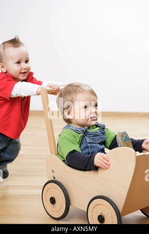 Two baby boys playing on bed Stock Photo - Alamy