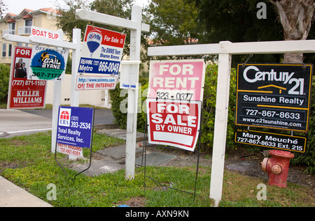 Signs showing many homes for sale Stock Photo - Alamy