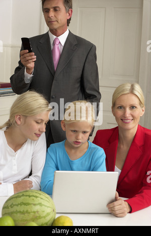 Teenager with mobile phone sitting next to his electric scooter and ...