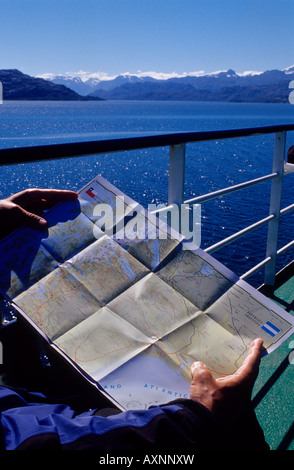 Tourist watching a Patagonian Channels Map on the ferry from Puerto ...