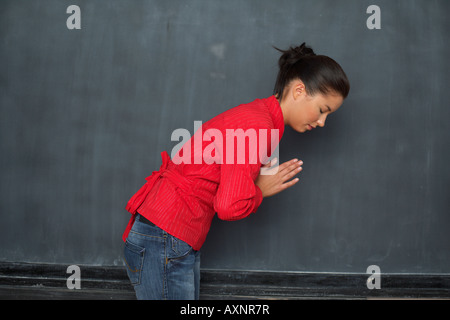 Asian woman bowing in front of a Caucasian man Stock Photo - Alamy