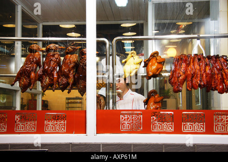 Window display of Peking crispy duck hanging air drying in Chinese ...