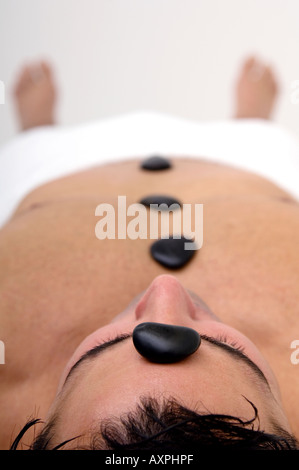 Man receiving stone therapy Stock Photo - Alamy