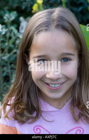 young girl smiling cheekily Stock Photo - Alamy
