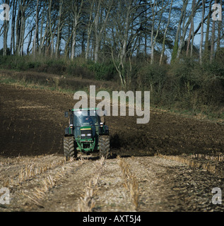 John Deere tractor spreading muck onto maize stubble before cultivation ...