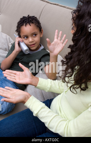Portrait of a mom on the phone ignoring her daughter Stock Photo - Alamy