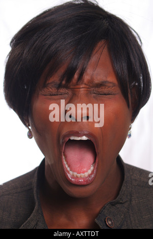 Beautiful girl screaming loud with mouth wide open Stock Photo - Alamy