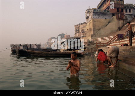 Hindu Pilgrims Praying and Bathing In The Holy River Ganges, Varanasi ...