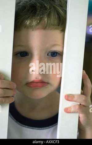 Boy looking through bars in black and white Stock Photo - Alamy