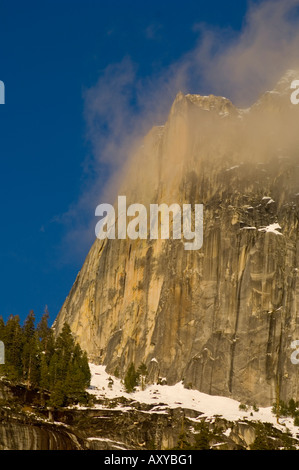 Cloud forming against the huge granite rock cliff face of Half Dome at ...