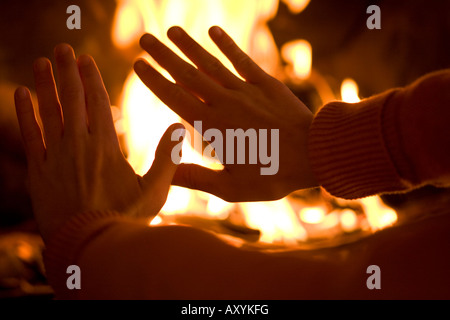 Person warming their hands over a fire Stock Photo: 16816036 - Alamy