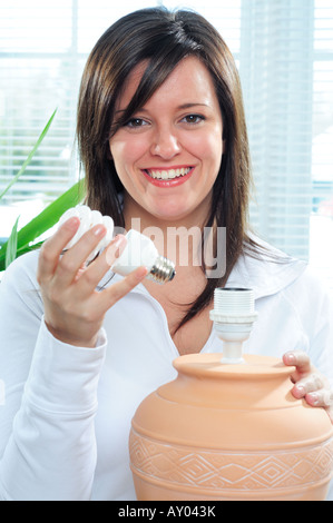 Attractive woman with energy saving bulb Stock Photo - Alamy