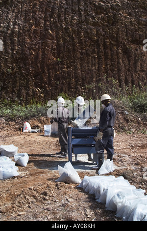 Grade control sampling in surface gold mine opencast pit with geologist ...