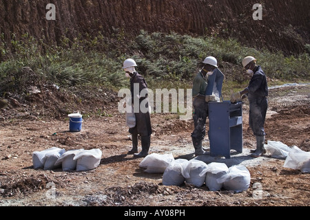 Grade control sampling in surface gold mine opencast pit with geologist ...