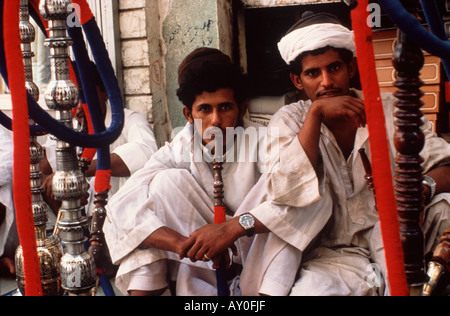 young saudi arabian man smoking arabic hubble bubble hookah pipe in the ...