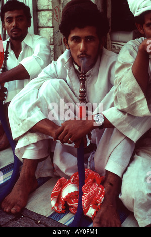 young saudi arabian man smoking arabic hubble bubble hookah pipe in the ...