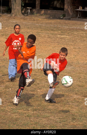 Diverse children playing soccer football at school Stock Photo - Alamy