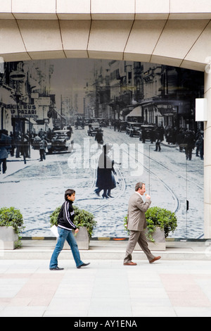 People walk past the Wall Street subway station in the Financial ...