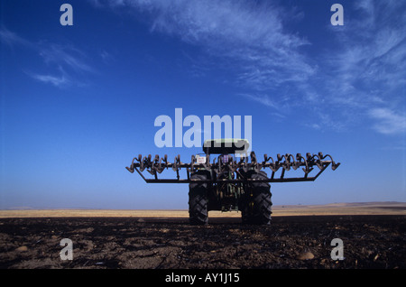 A harrow a sort of shallow plough mounted on the back of a tractor rear ...