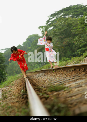 Two girls walking on railroad tracks Stock Photo - Alamy