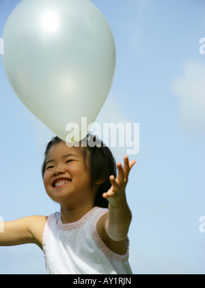 Close-up of a girl catching a balloon Stock Photo - Alamy