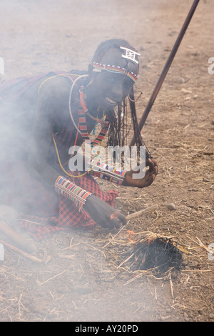 Masai man cooking Stock Photo - Alamy