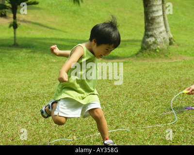 Boy jumping rope on grass, in air Stock Photo: 6329103 - Alamy