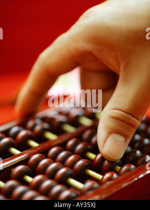 Hand using a color abacus Stock Photo - Alamy