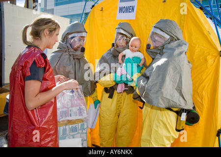 Wearing disposable emergency clothing a volunteer victim enter a Stock ...